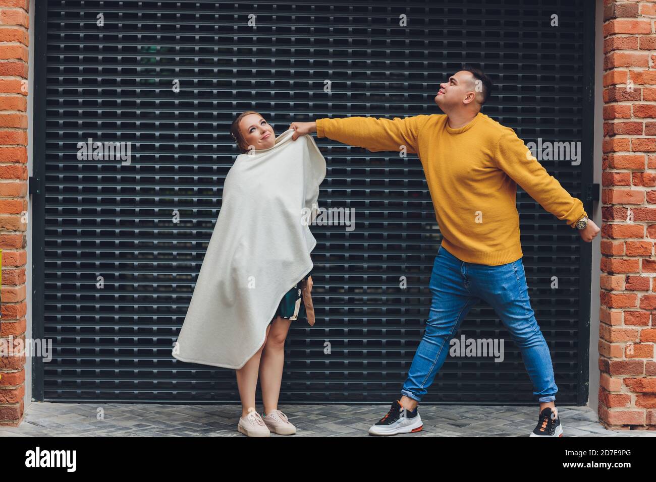 Young and trendy man and woman models walks on the street. in old town ...