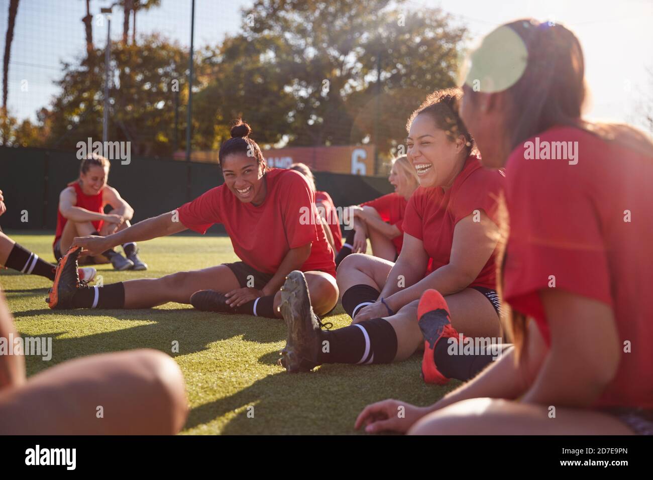 Womens Football Team Stretching Whilst Training For Soccer Match On ...