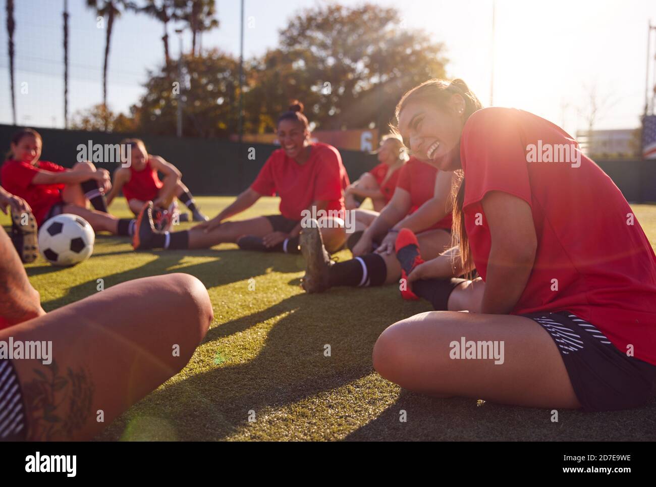 Womens Football Team Stretching Whilst Training For Soccer Match On ...