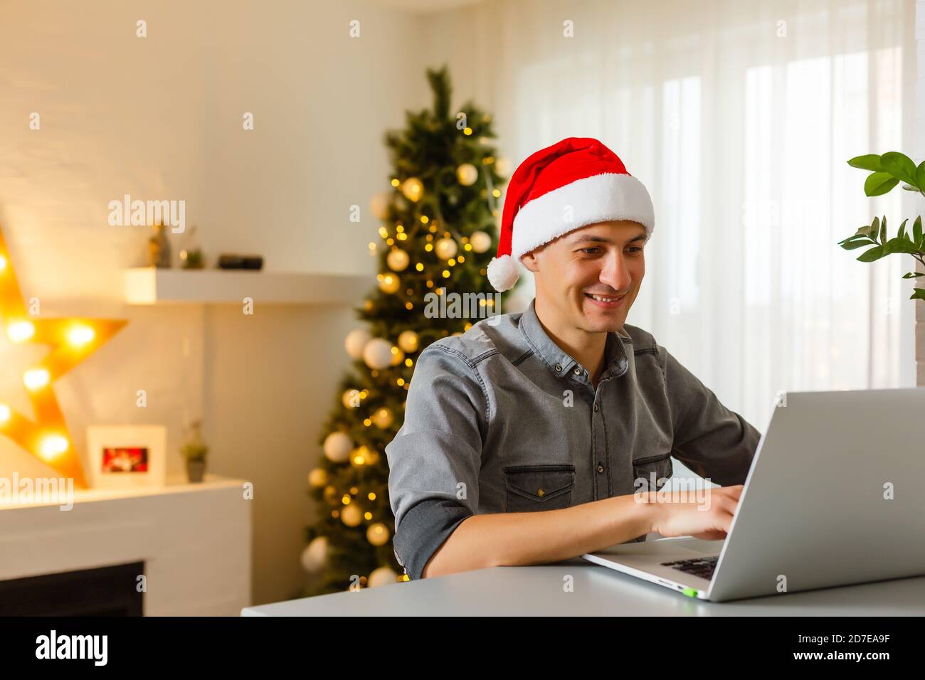 man in santa claus hat holding laptop with merry christmas typing Stock ...