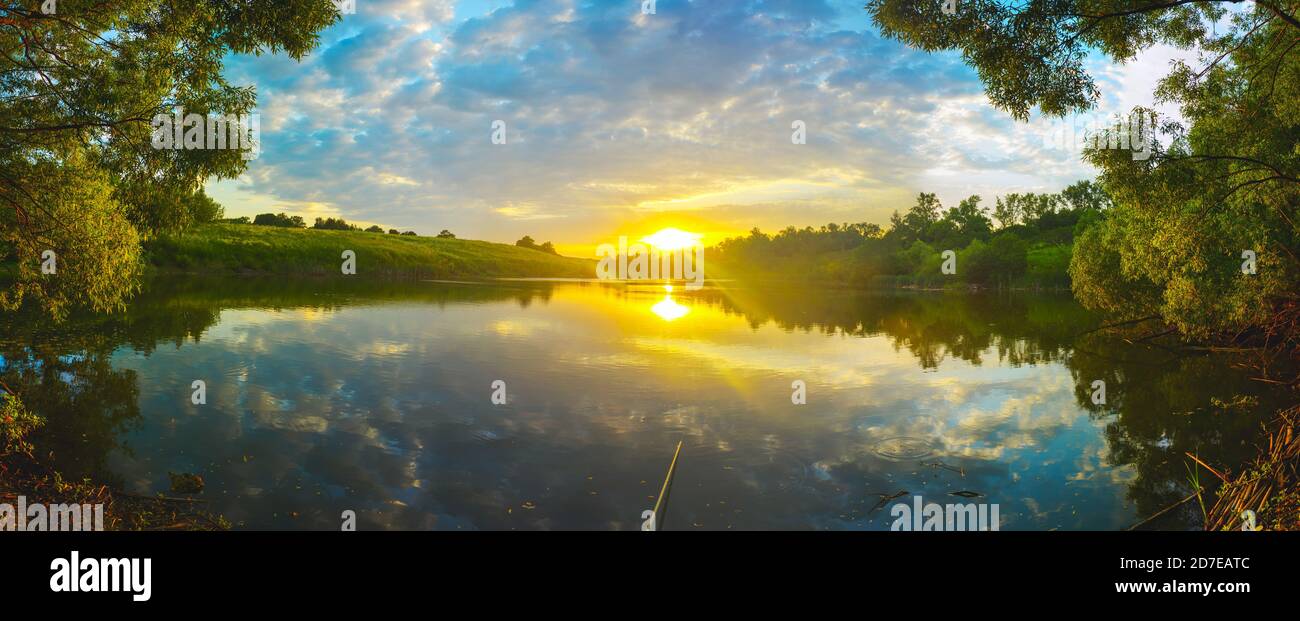 Tranquil evening scene with warm sunlight and amazing reflection of ...
