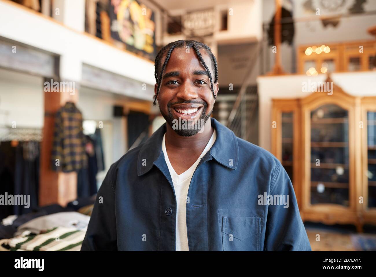 Portrait Of Smiling Male Owner Of Fashion Store Standing In Front Of ...