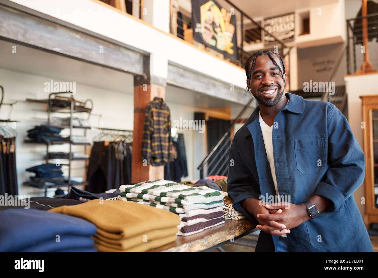 Portrait Of Smiling Male Owner Of Fashion Store Standing In Front Of ...