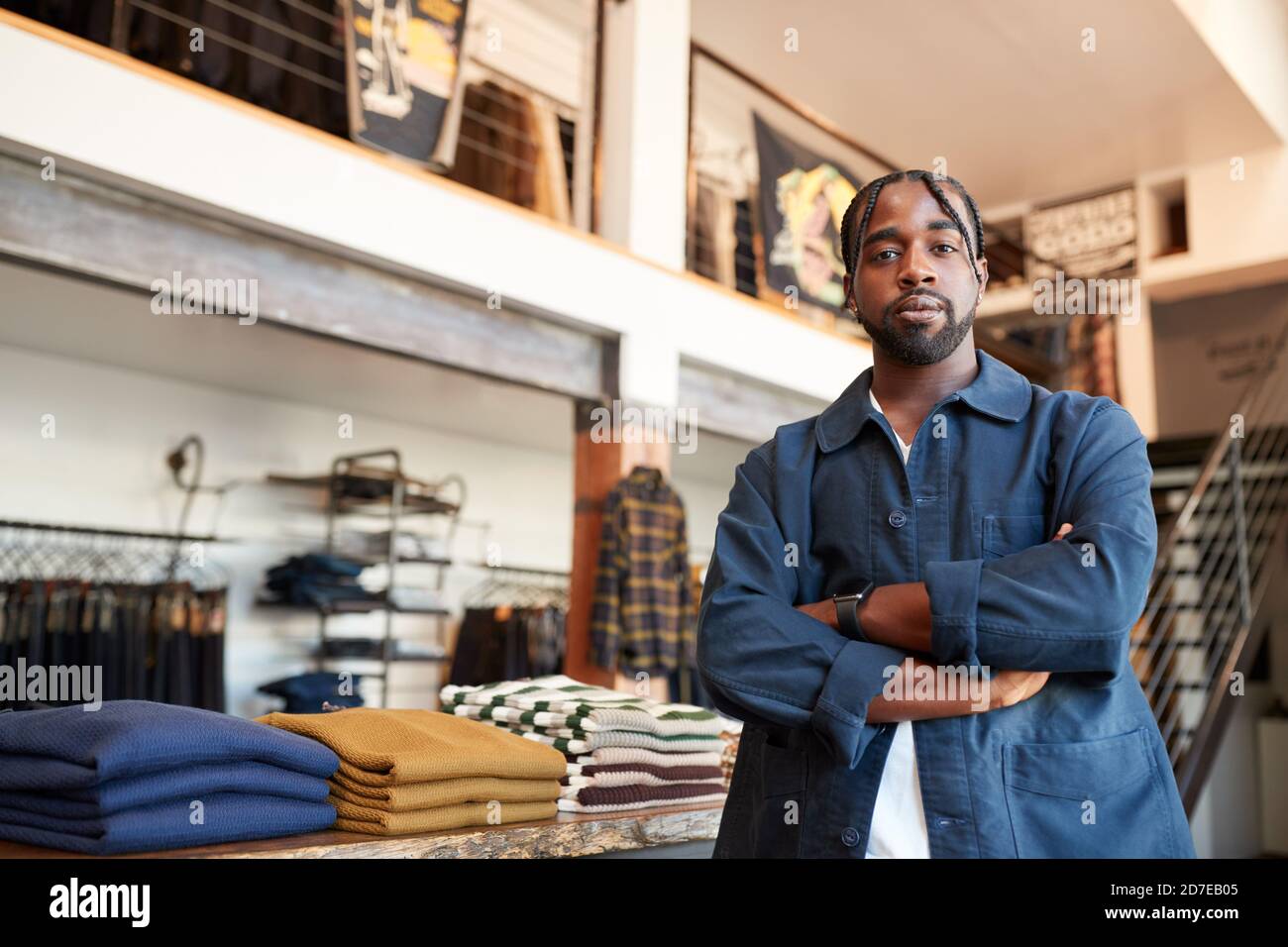 Portrait Of Male Owner Of Fashion Store Standing In Front Of Clothing ...