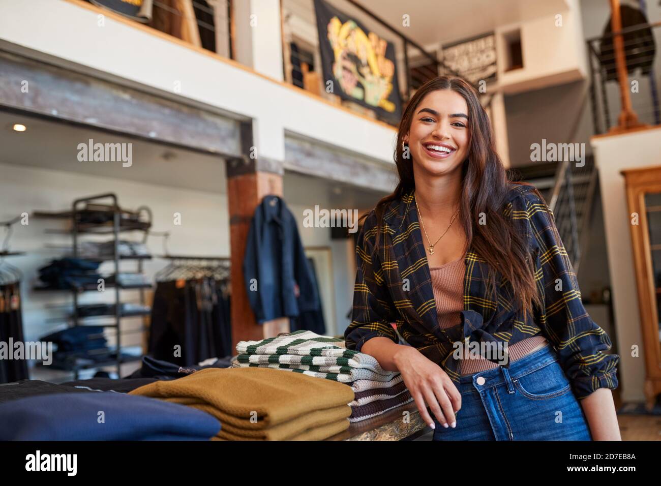 Portrait Of Smiling Female Owner Of Fashion Store Standing In Front Of ...