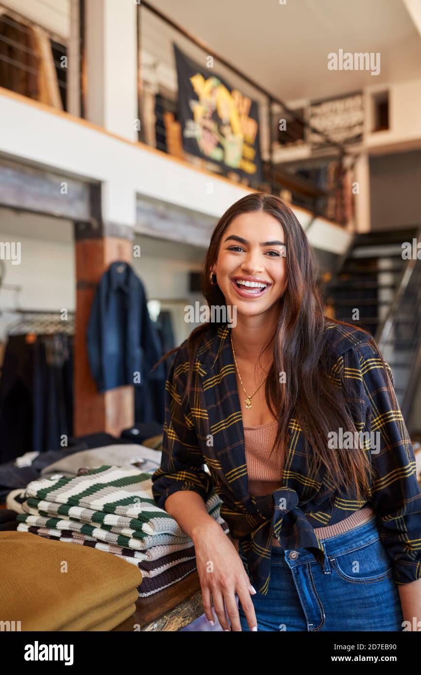 Portrait Of Smiling Female Owner Of Fashion Store Standing In Front Of ...