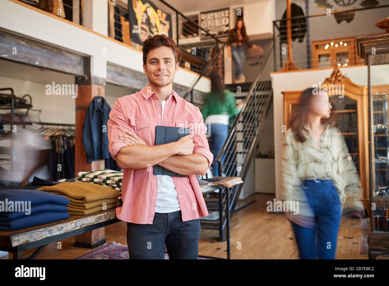 Portrait Of Male Owner Of Fashion Store With Digital Tablet In Busy ...