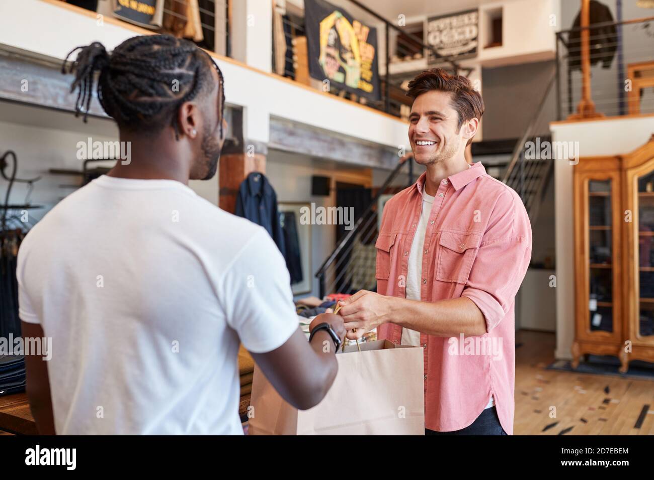 Handing bag to customer hi-res stock photography and images - Alamy
