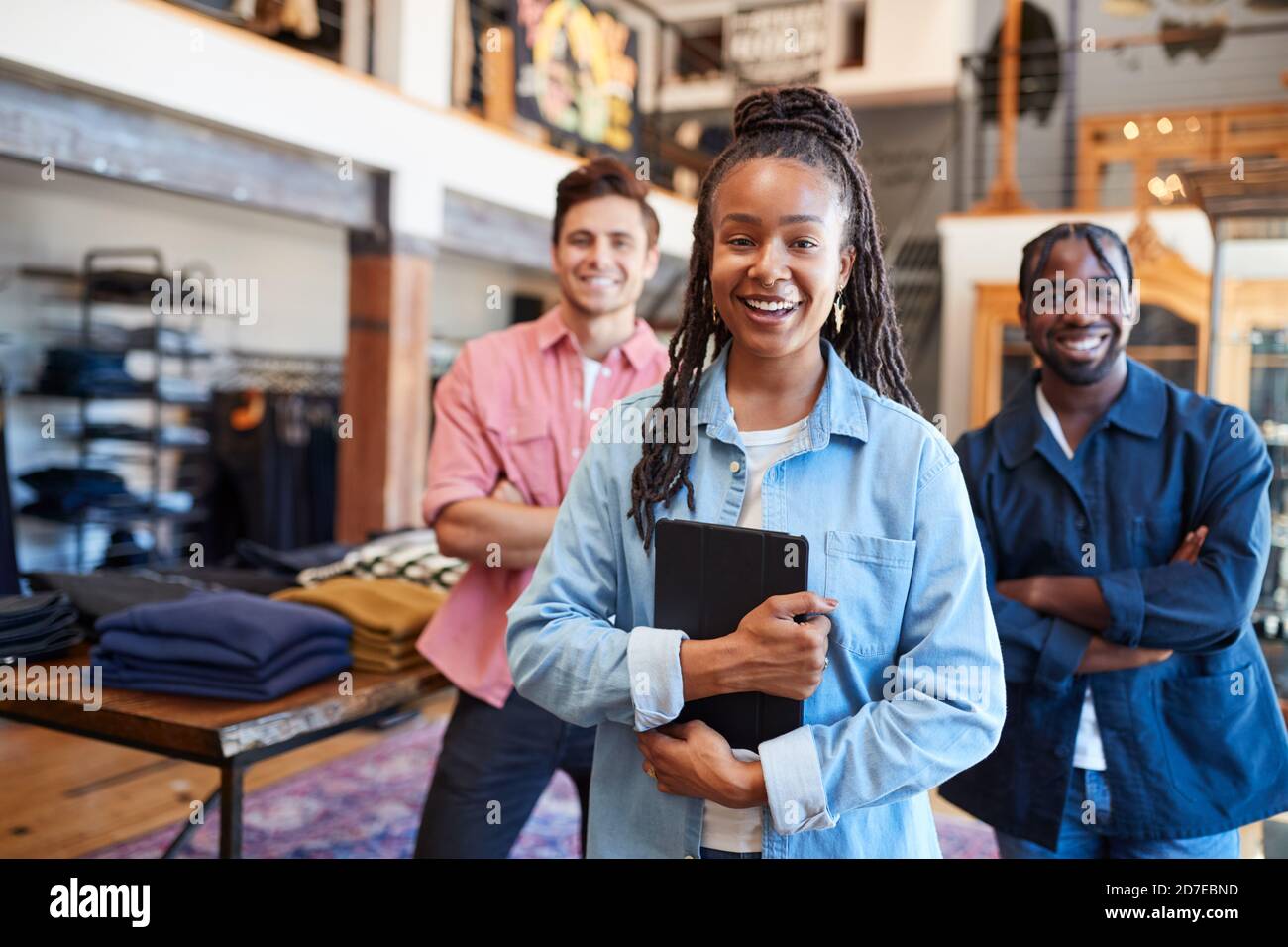 Portrait Of Smiling Multi-Cultural Sales Team In Fashion Store In Front ...