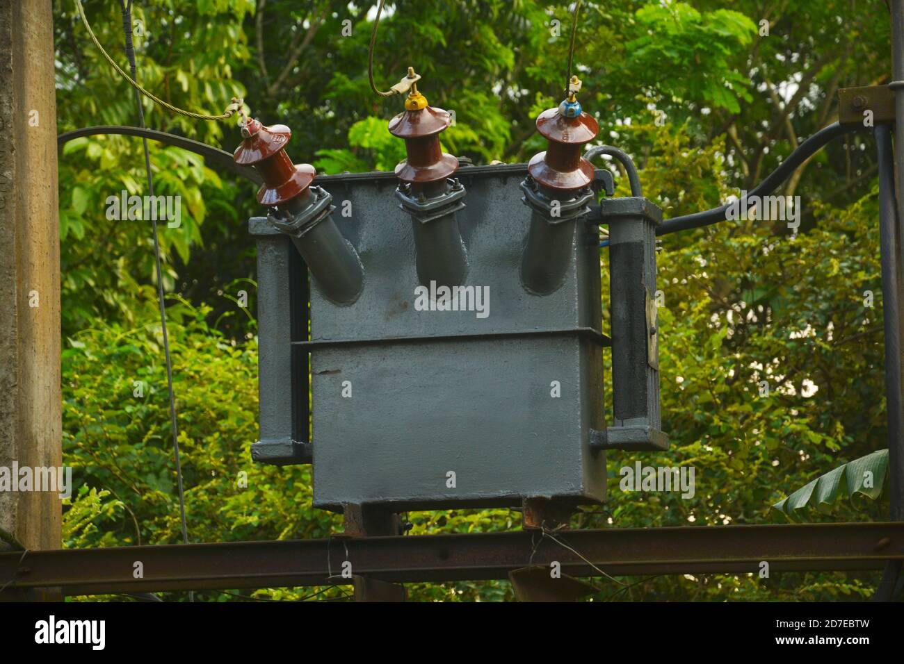 Close up of a three phase transformer with ceramic insulators and wires ...