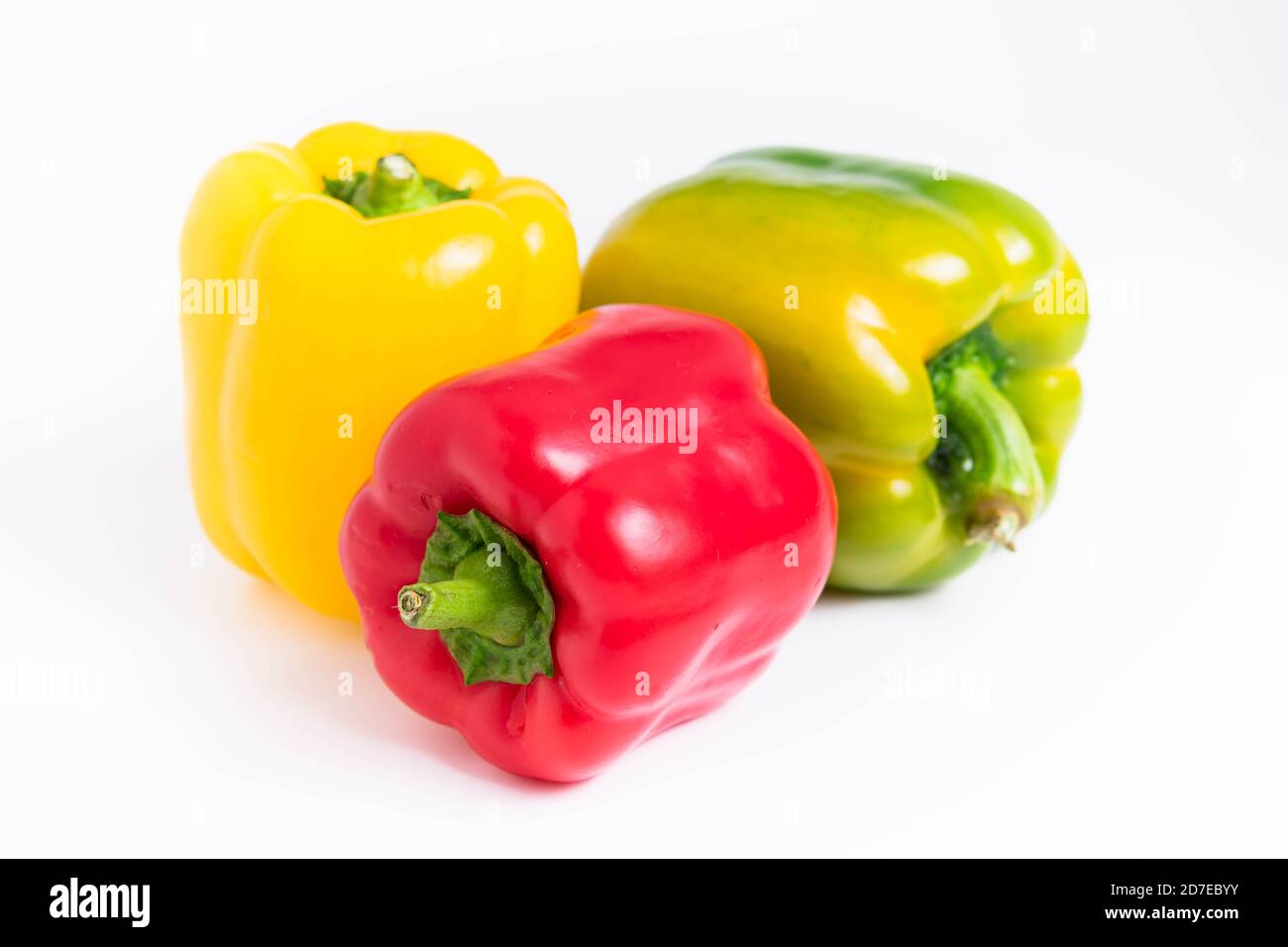 isolate, three ripe peppers of red, yellow, green colors, close-up on a ...