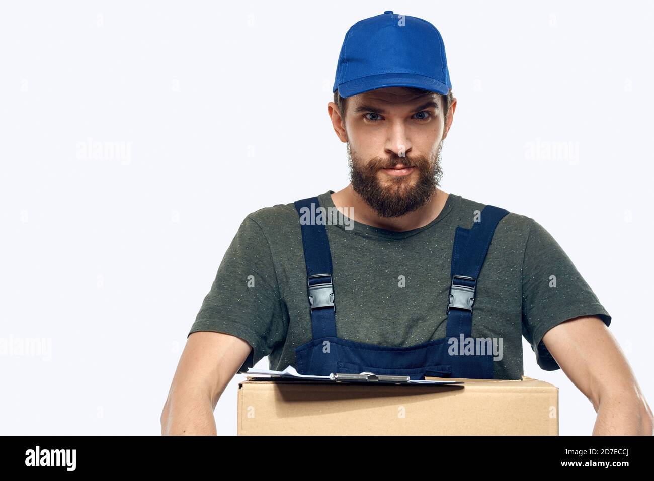 Working male courier with box in hand documents delivery service light ...