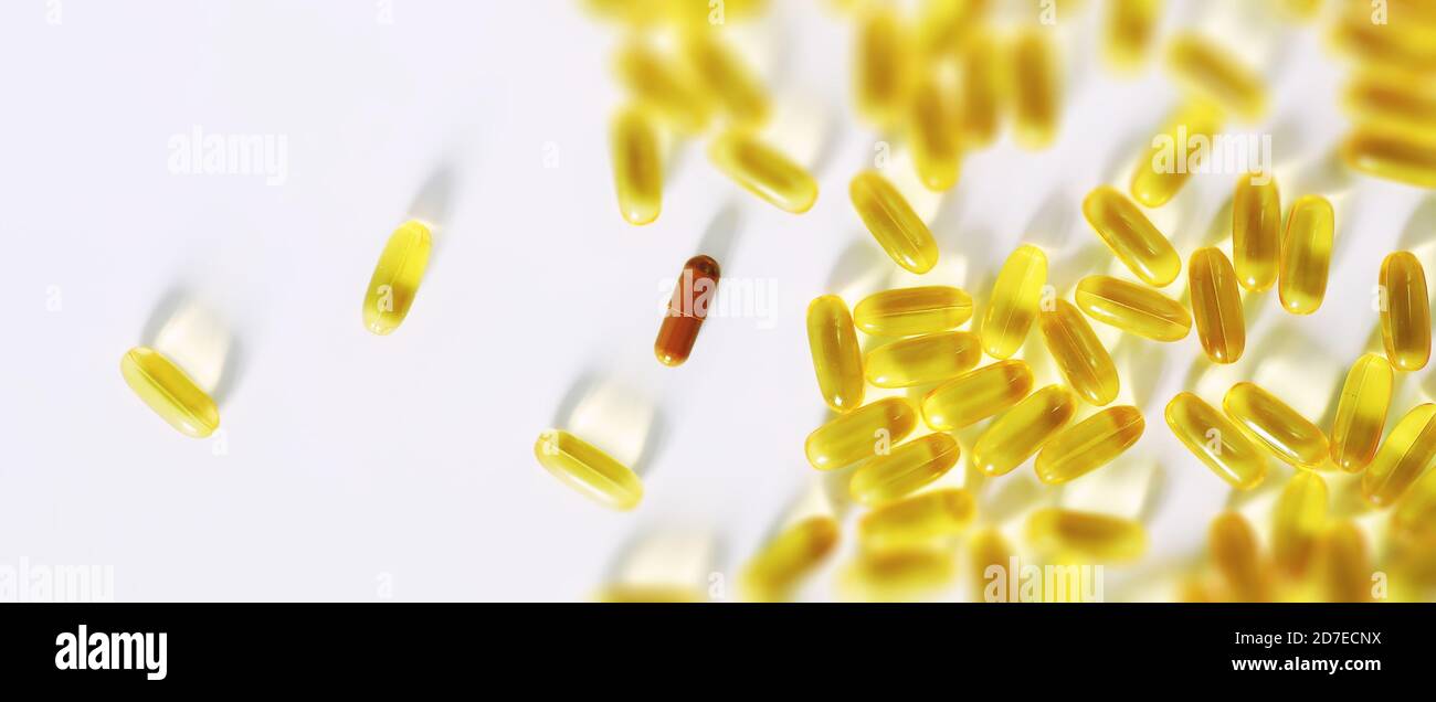 Medical medicines and supplements transparent capsules of yellow color ...