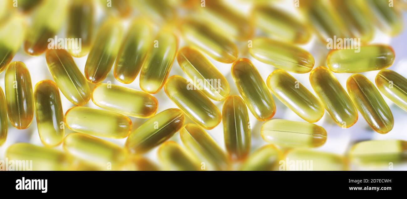 Medical medicines and supplements transparent capsules of yellow color ...