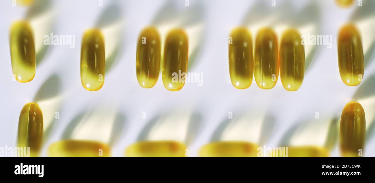 Medical medicines and supplements transparent capsules of yellow color ...