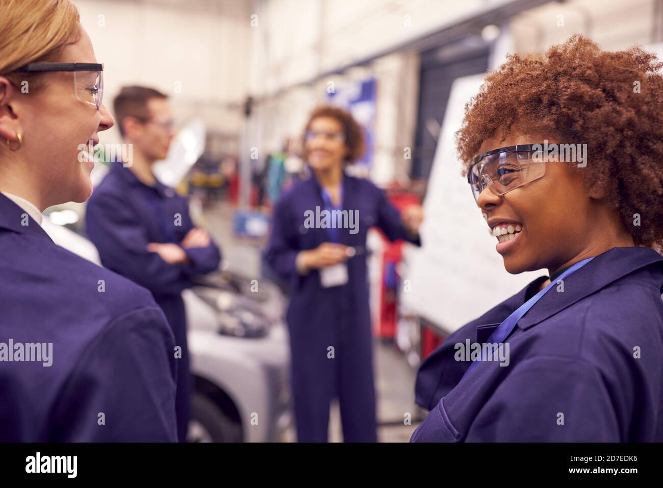 Female Tutor By Whiteboard With Students Teaching Auto Mechanic ...