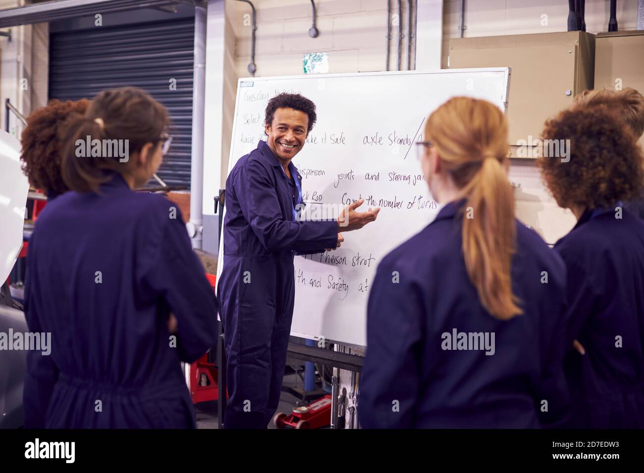 Male Tutor By Whiteboard With Students Teaching Auto Mechanic ...