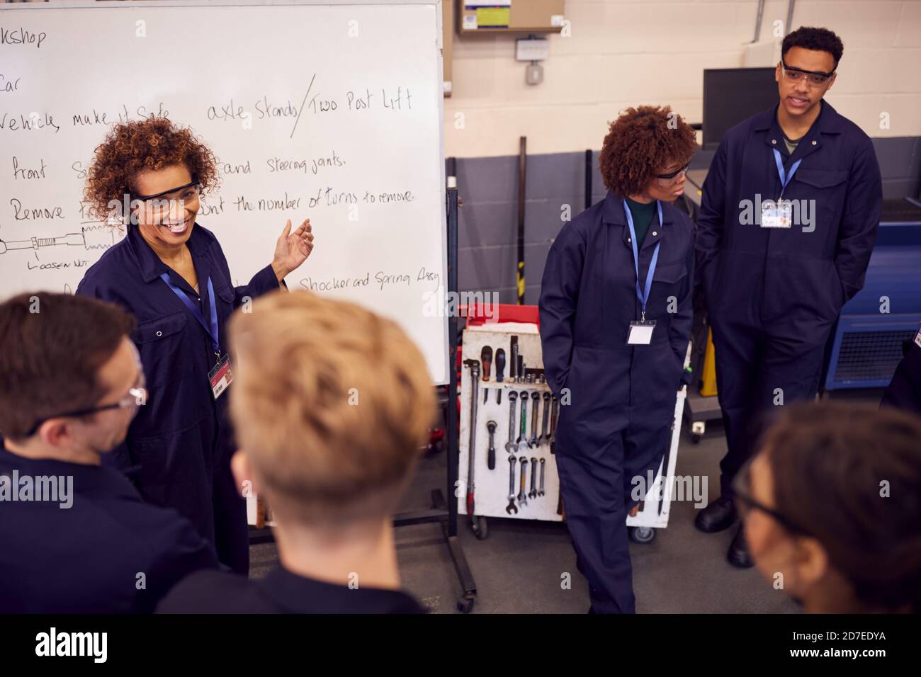 Female Tutor By Whiteboard With Students Teaching Auto Mechanic ...