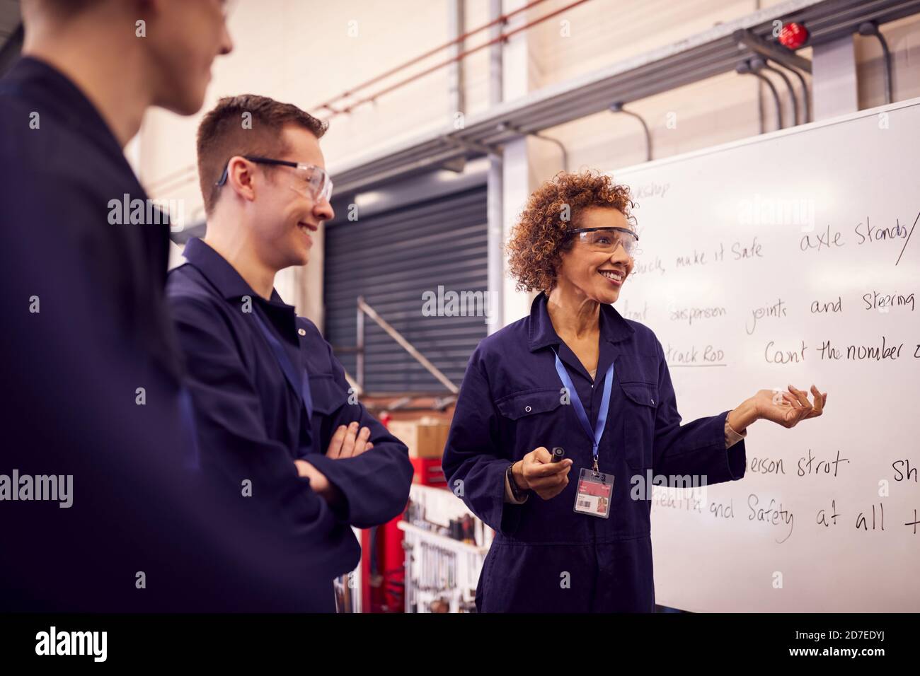 Female Tutor By Whiteboard With Students Teaching Auto Mechanic ...