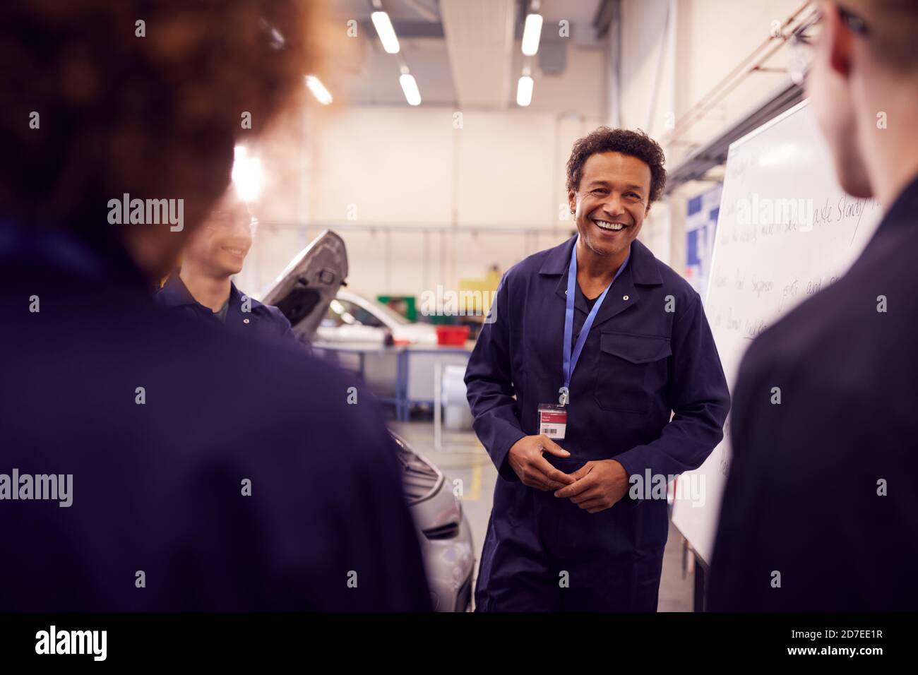 Male Tutor By Whiteboard With Students Teaching Auto Mechanic ...