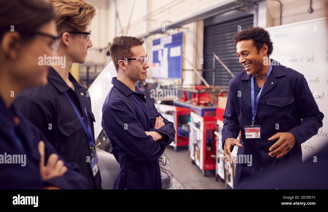 Male Tutor By Whiteboard With Students Teaching Auto Mechanic ...