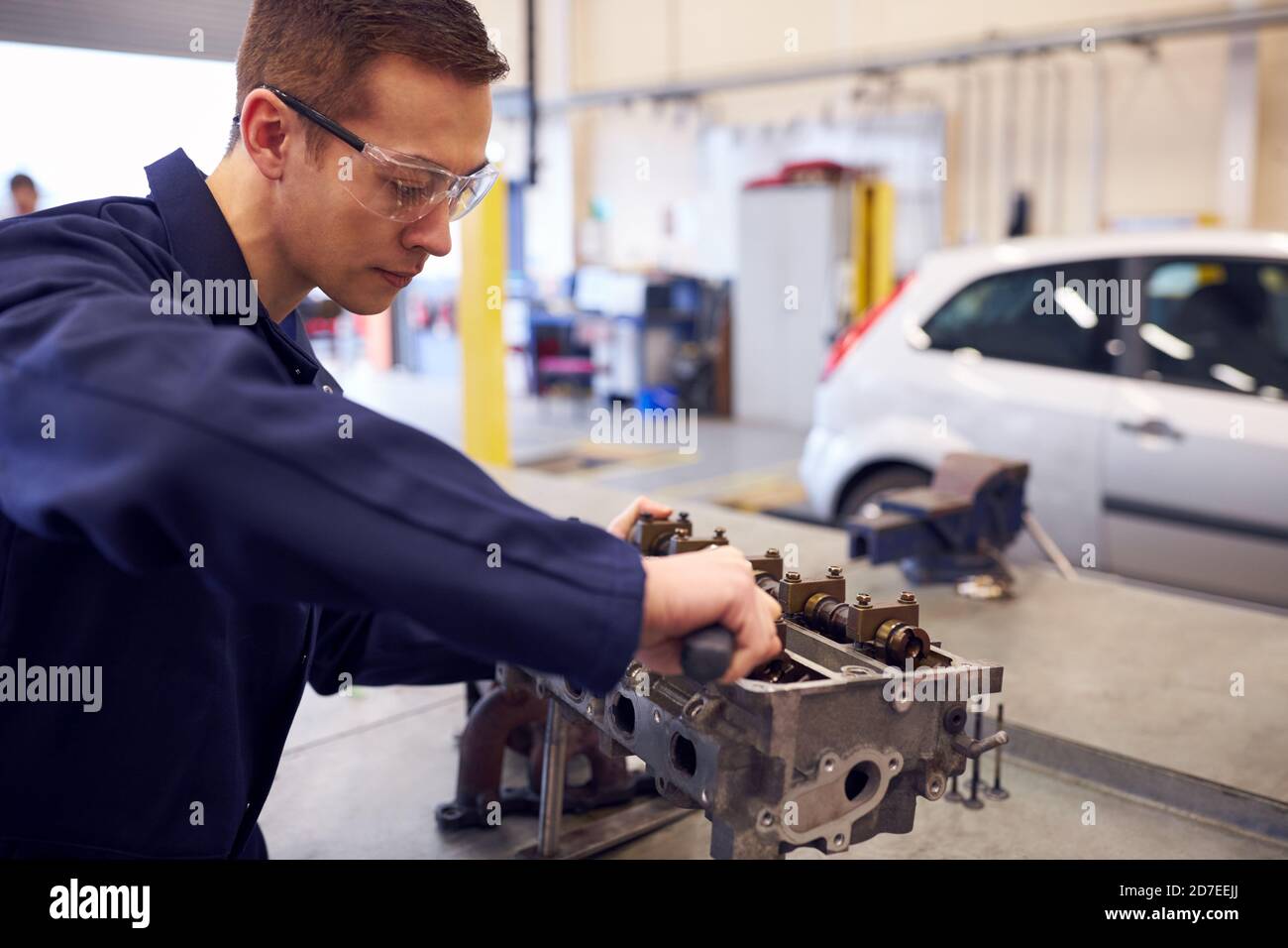 Female Student Works On Car Engine Block On Auto Mechanic ...