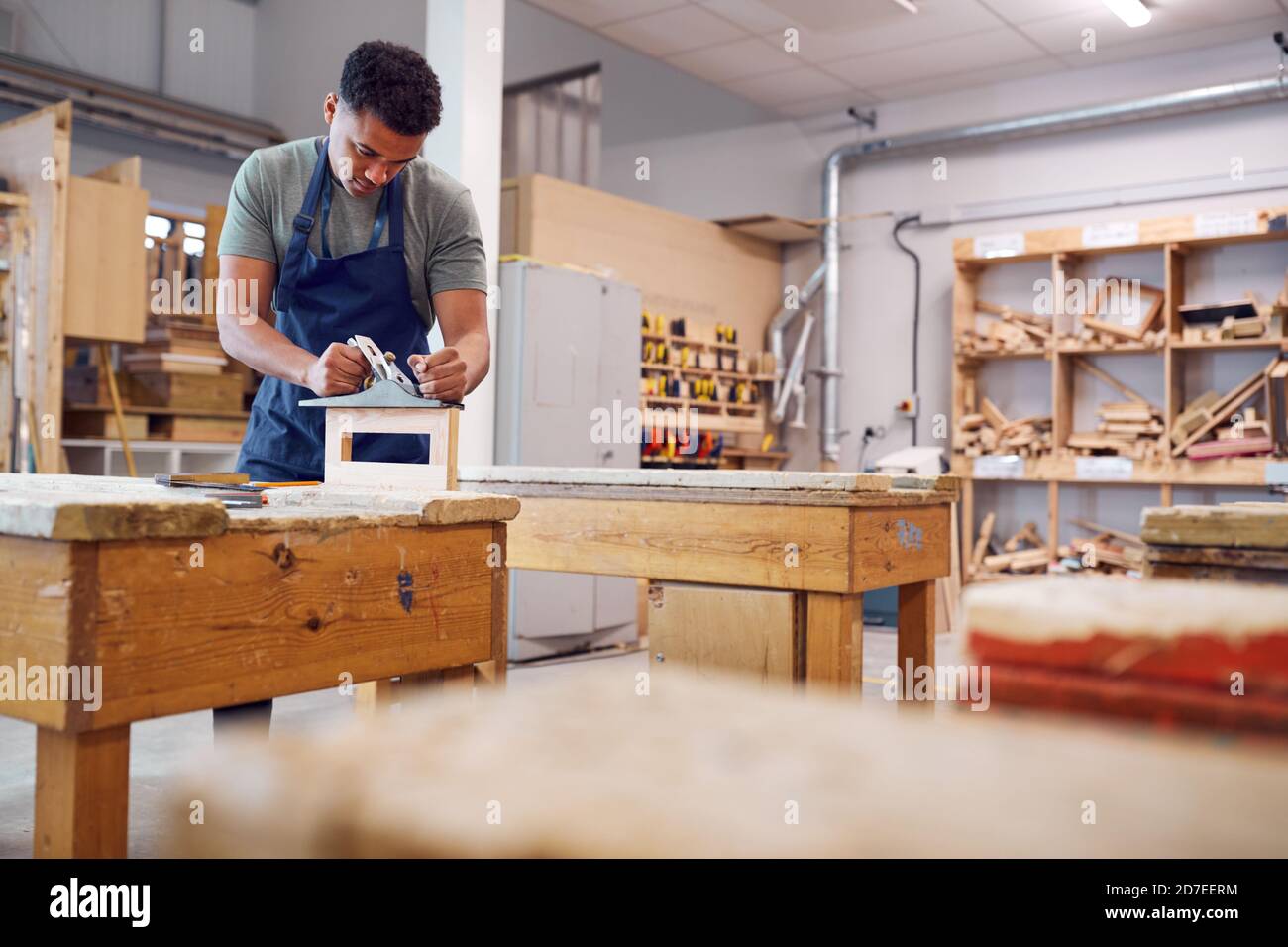 Male Student Studying For Carpentry Apprenticeship At College Using ...