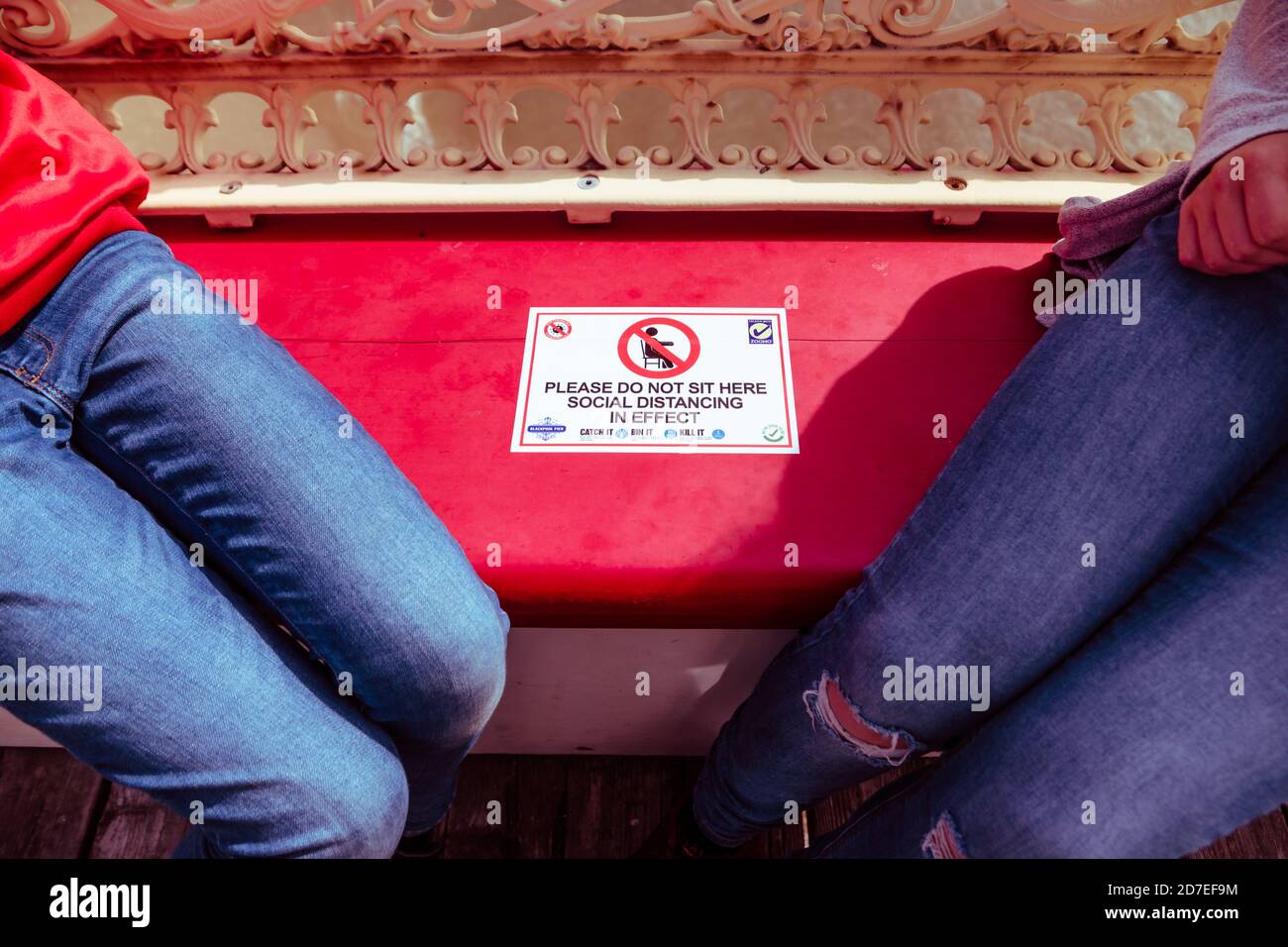 Social distancing sign on a bench seat in the Covid-19 pandemic Stock ...