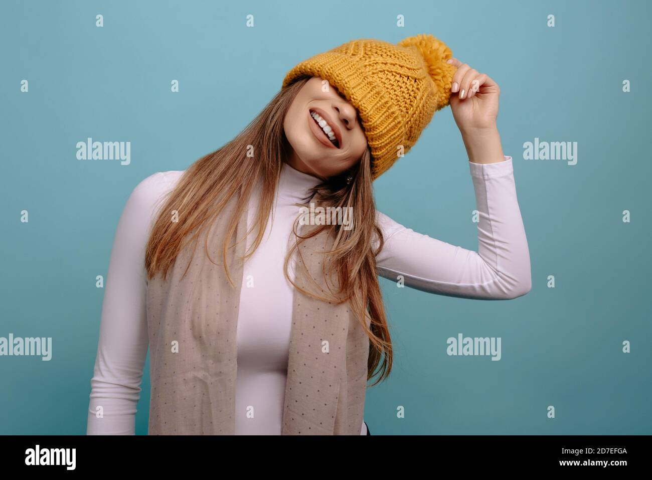 Portrait of funny, positive woman with the hat over his eyes smiling at ...