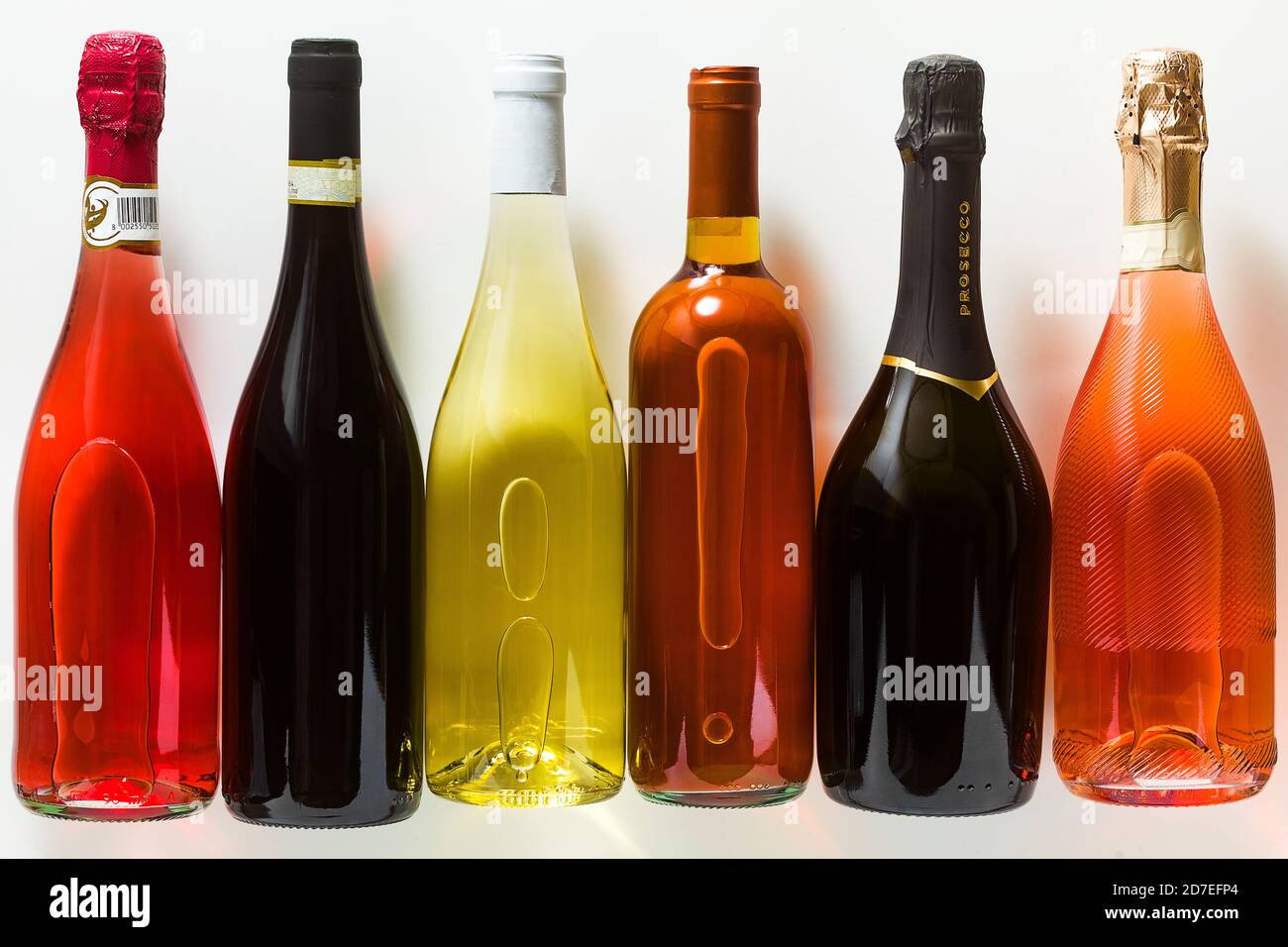different bottles with alcohol on a white background: white, red ...