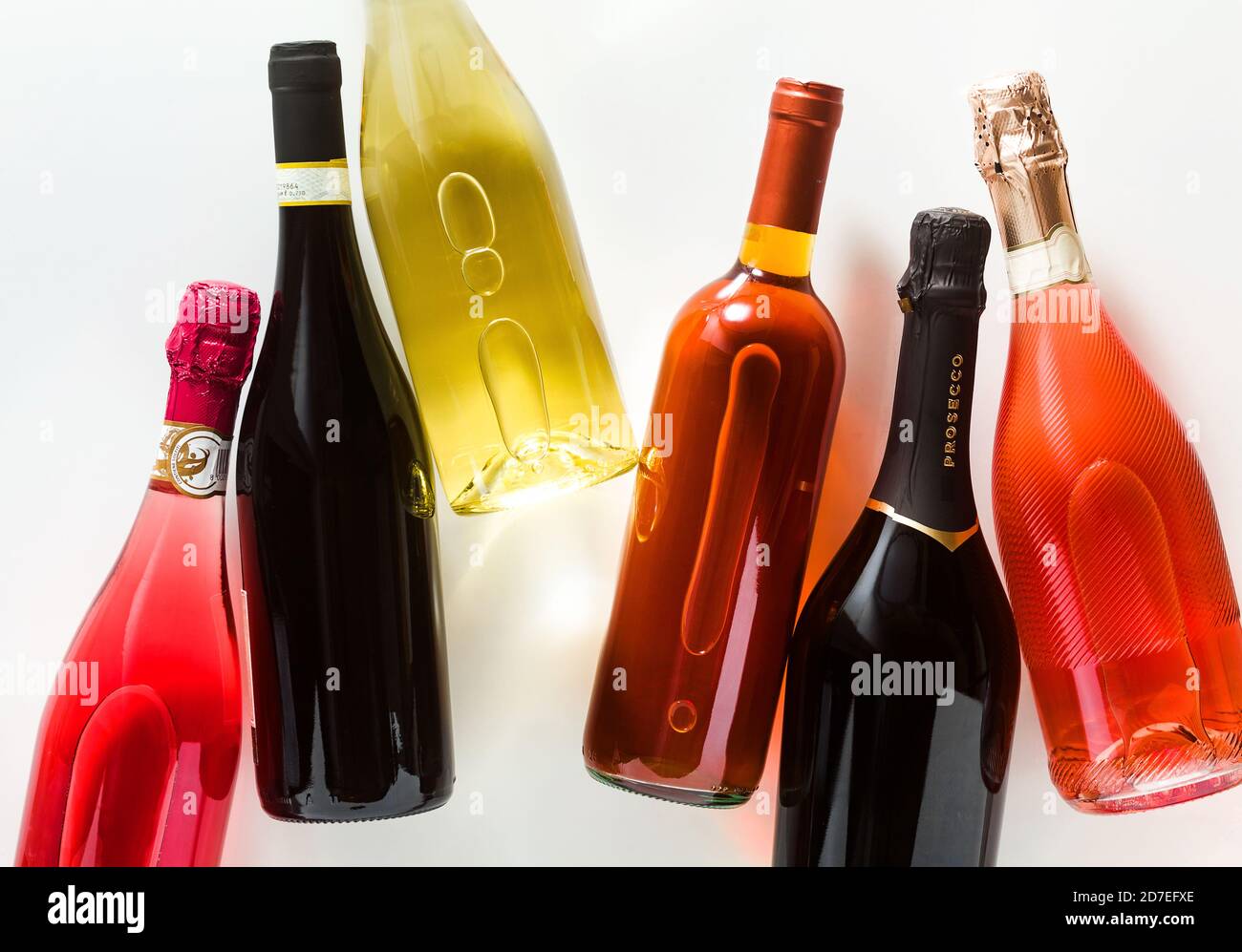 different bottles with alcohol on a white background: white, red ...