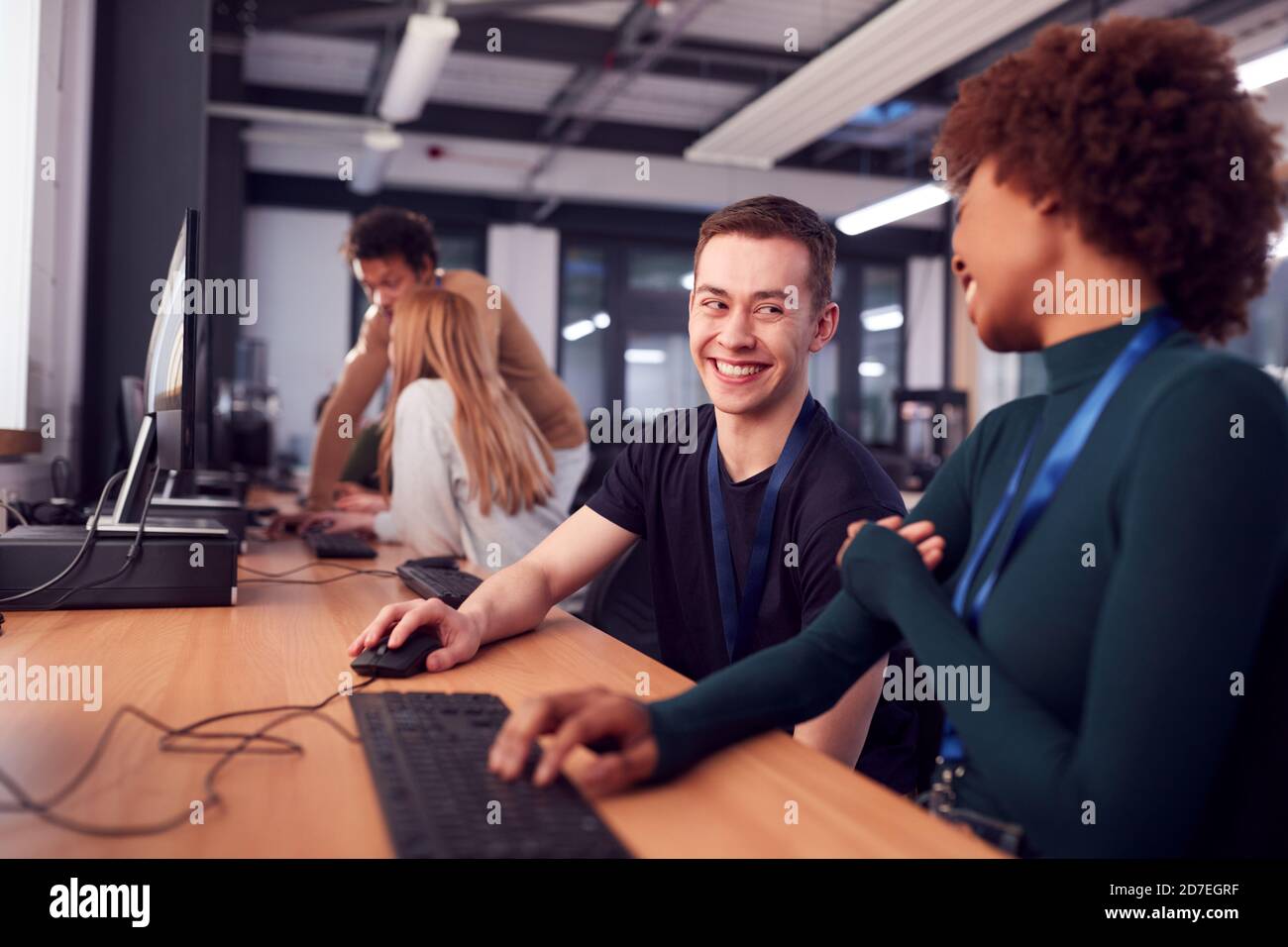Group Of College Students With Tutor Studying Computer Design Sitting ...