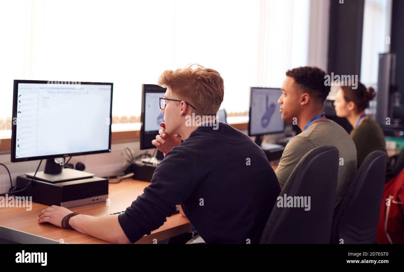 Group Of College Students Studying Computer Design Sitting At Line Of ...