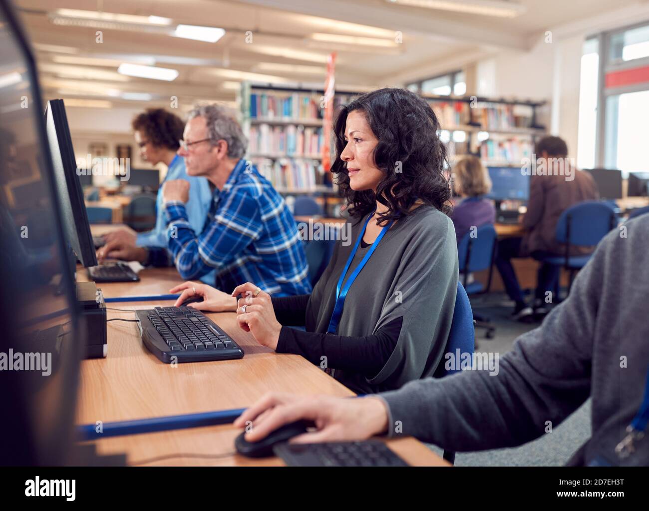 Group Of Mature Adult Students In Class Working At Computers In College ...