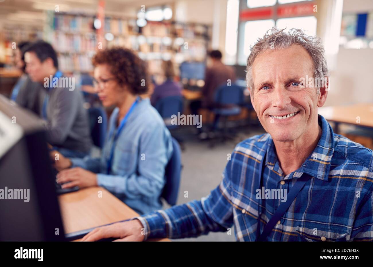 Portrait Of Male Mature Adult Student In Class Working At Computers In ...