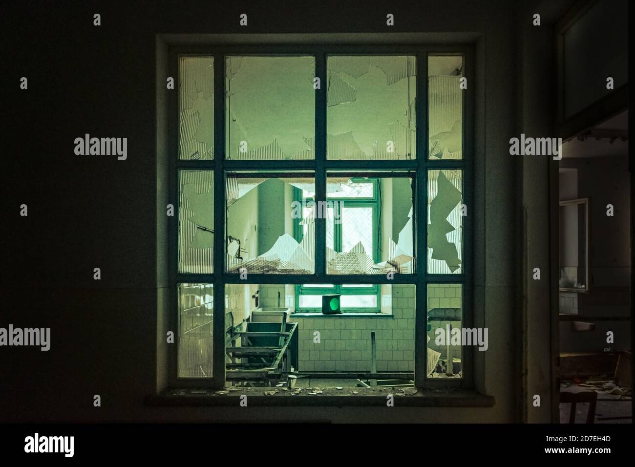 Internal window with broken glass from which you can see the remains of ...