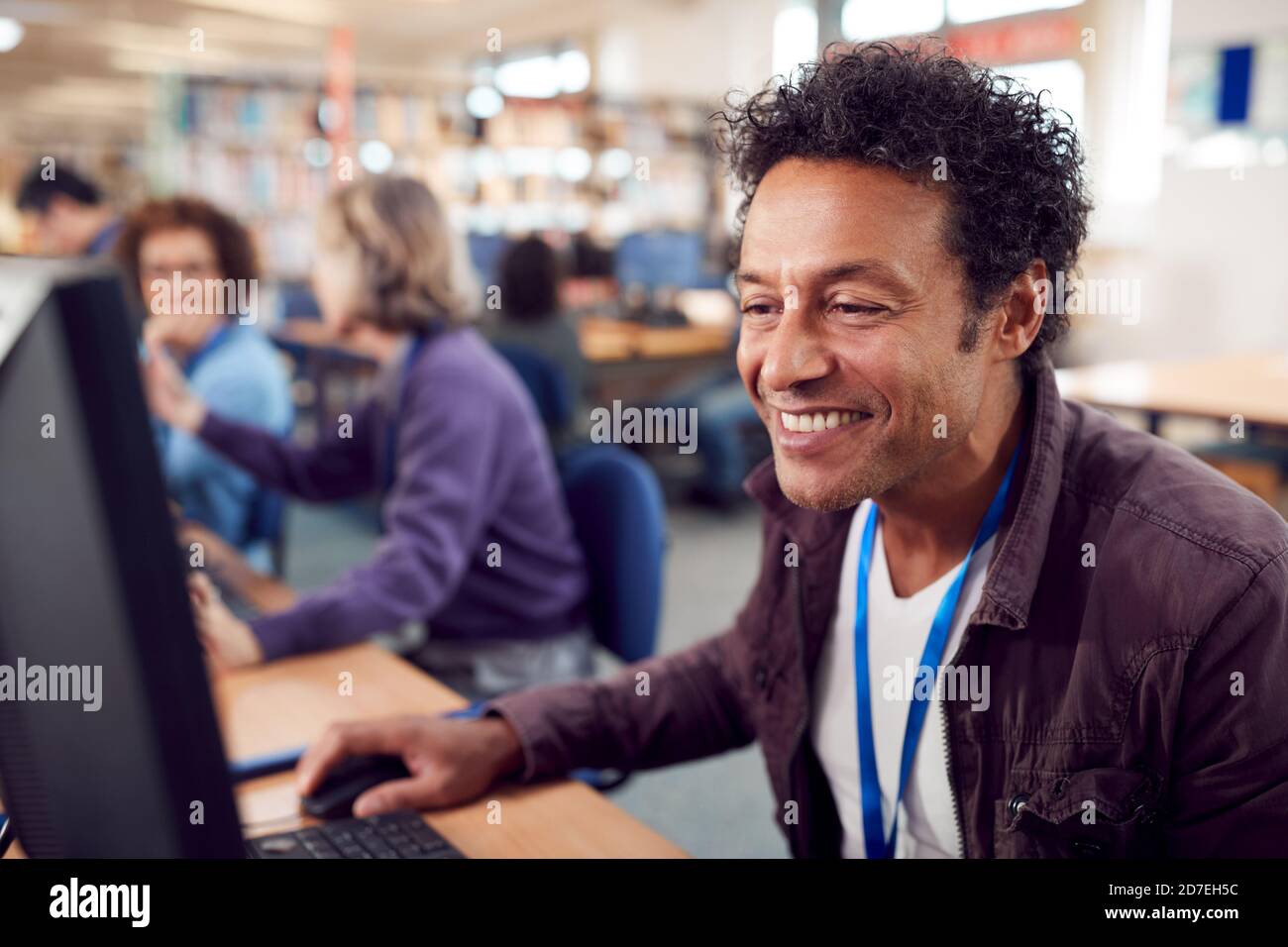 Group Of Mature Adult Students In Class Working At Computers In College ...