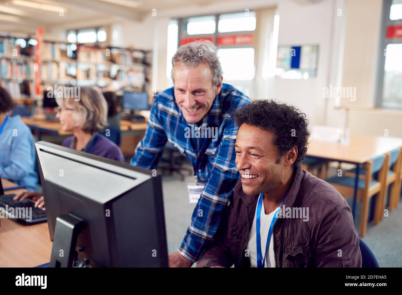Teacher With Group Of Mature Adult Students In Class Working At ...