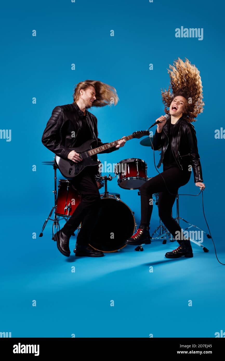 Full size photo crazy funky two people youth rock band woman sing song ...
