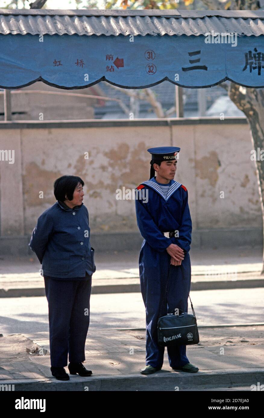 People's Liberation Army Navy sailor at bus stop, Nanjing, China, 1980 ...