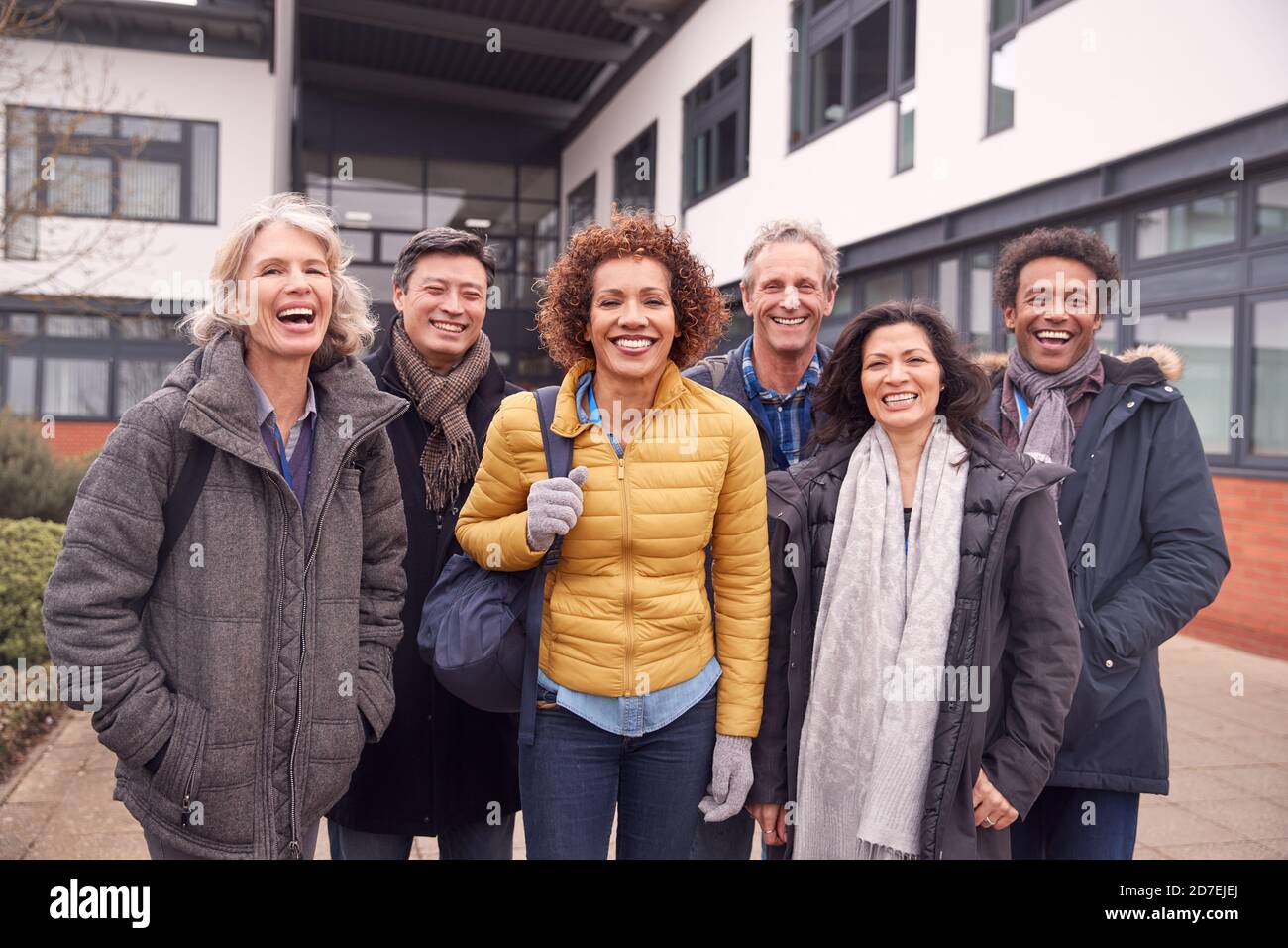 Portrait Of Group Of Smiling Mature Students Standing Outside College ...