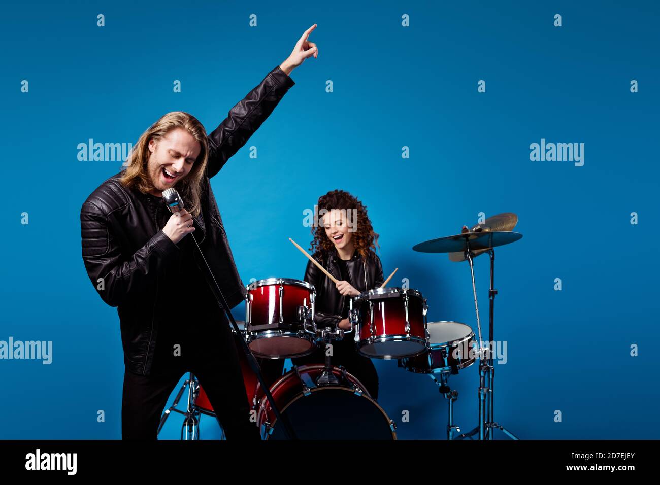 Portrait of crazy funky popular rock band two people man sing mic ...