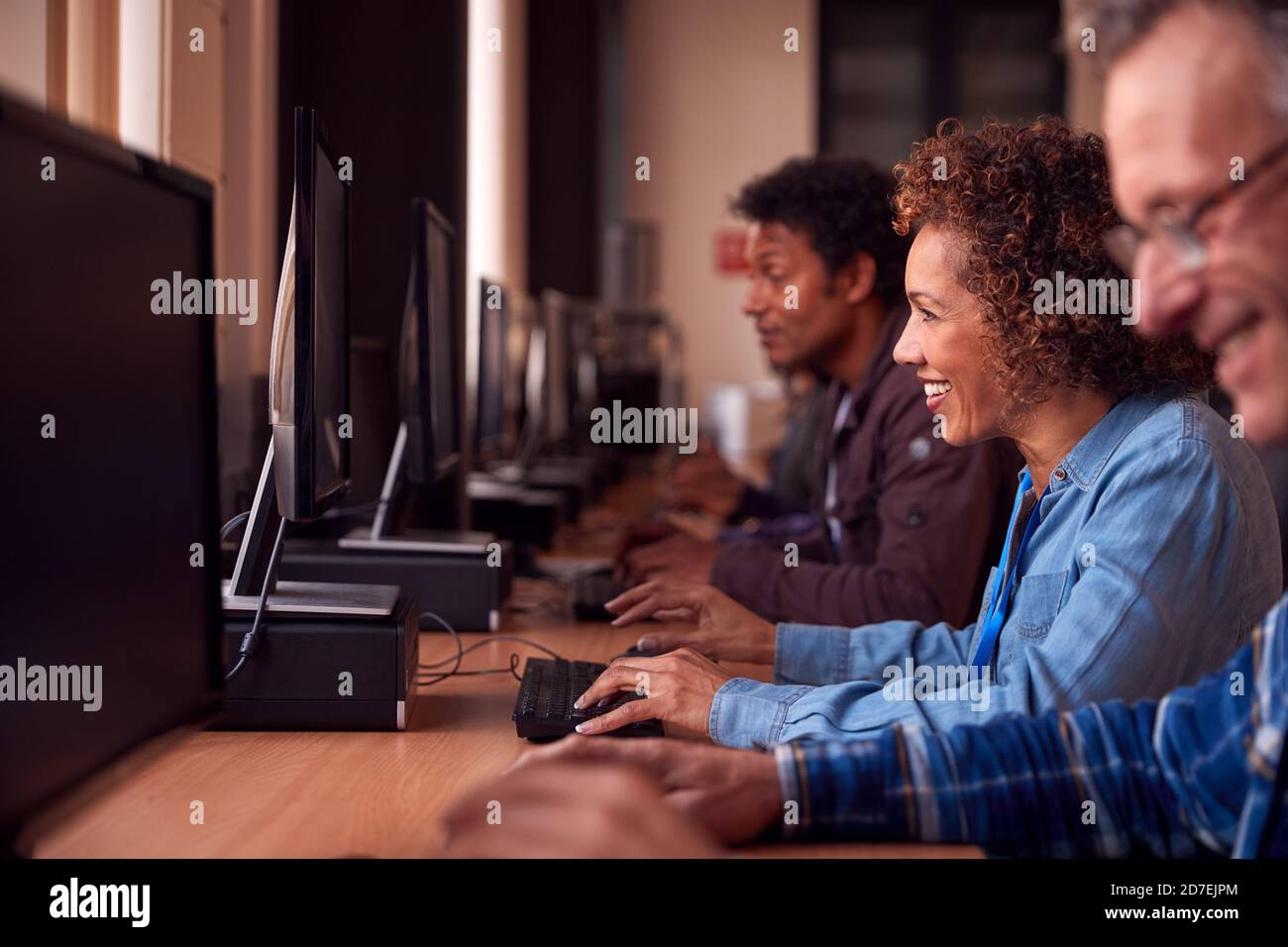 Group Of Mature Adult Students In Class Working At Computers In College ...