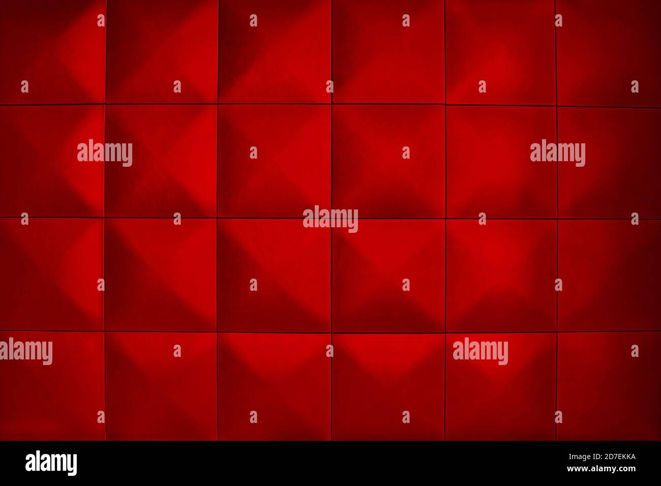 Rhombic red color wall of big squares. Background consists of large red ...