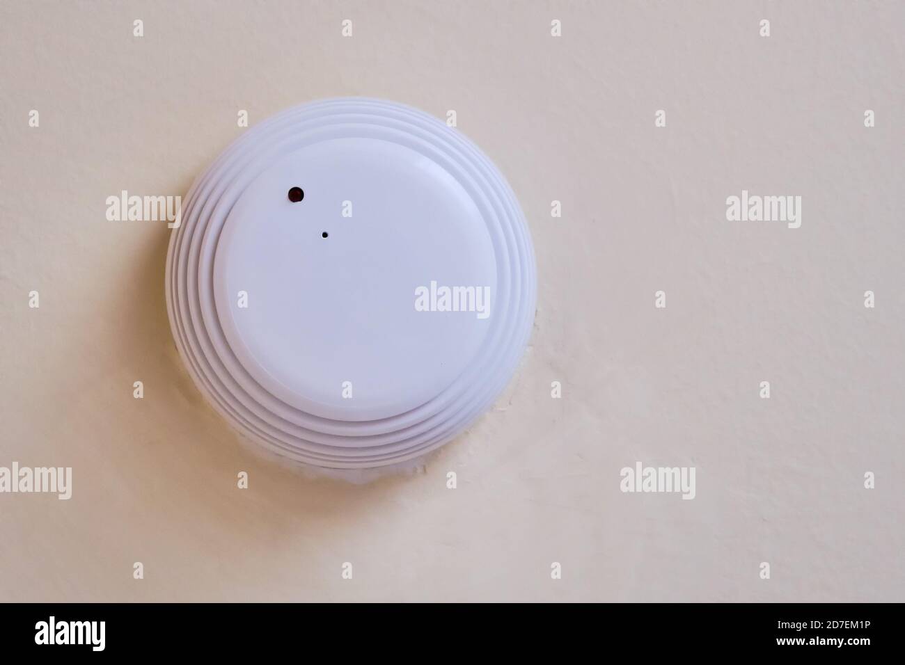 Smoke detector of fire alarm, the white background of the wall. Sensor ...