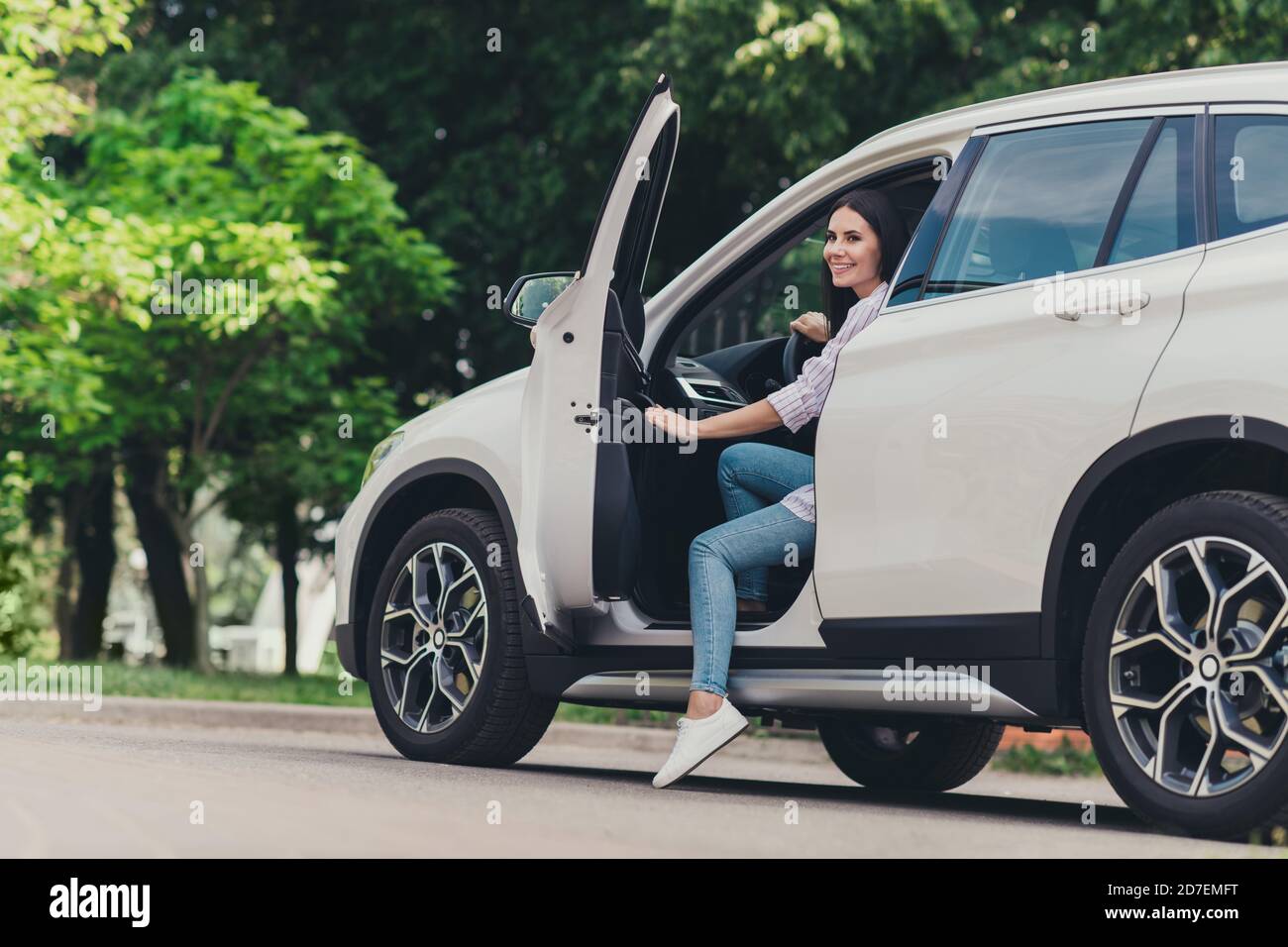 Full size photo of positive cheerful girl ride drive car arrive ...