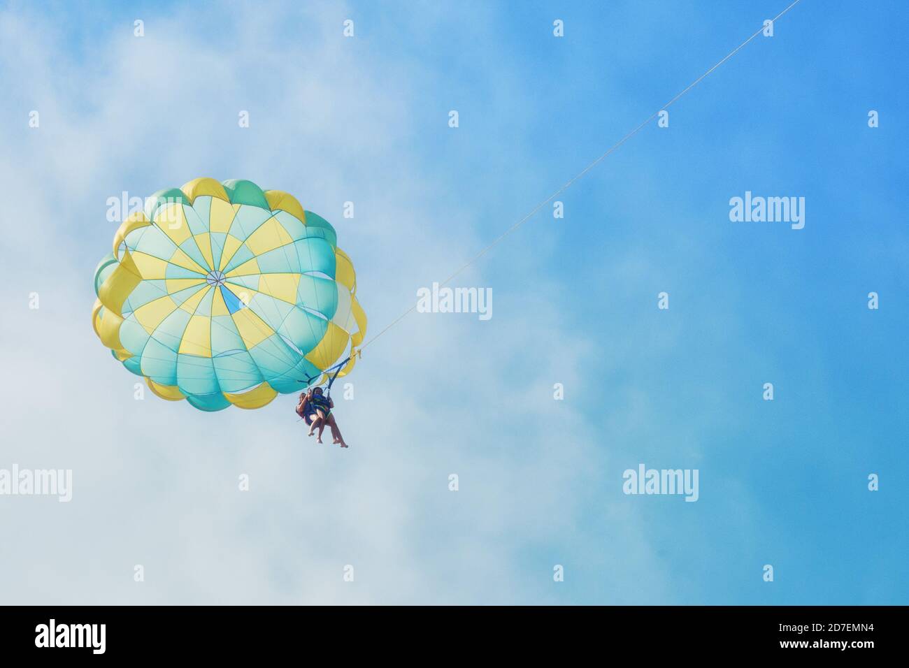Parasailing on blue sky, an attraction for tourists Stock Photo - Alamy