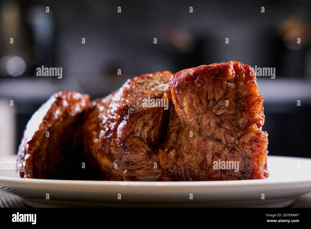 Big piece of meat on plate. Roast beef close-up. Barbecue meat in ...