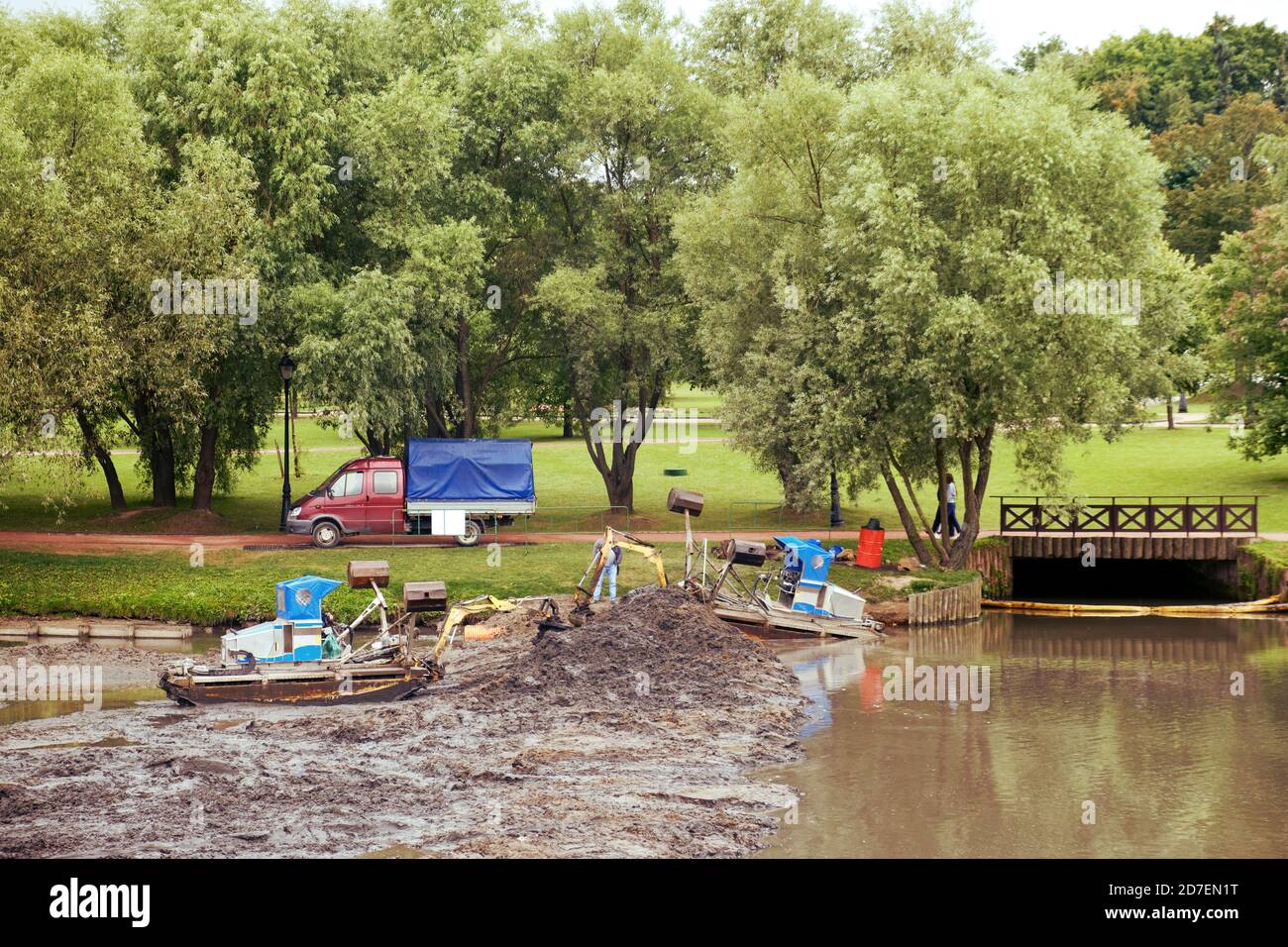 Amphibious machines and excavators clean the river from dirt Stock ...