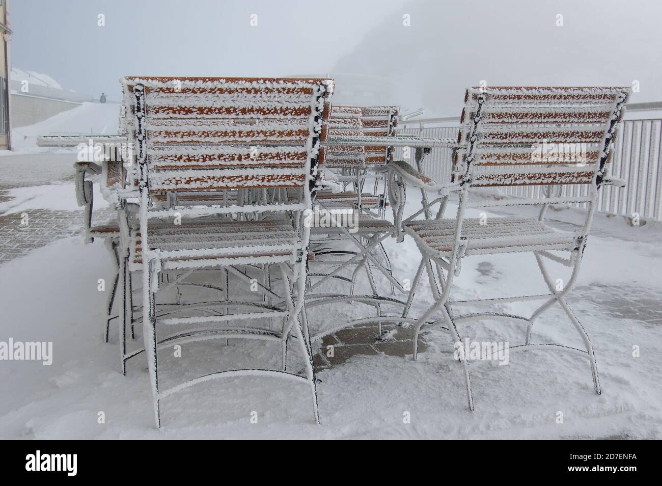 frozen chairs and table on the top terrace of Mount Pilatus in ...